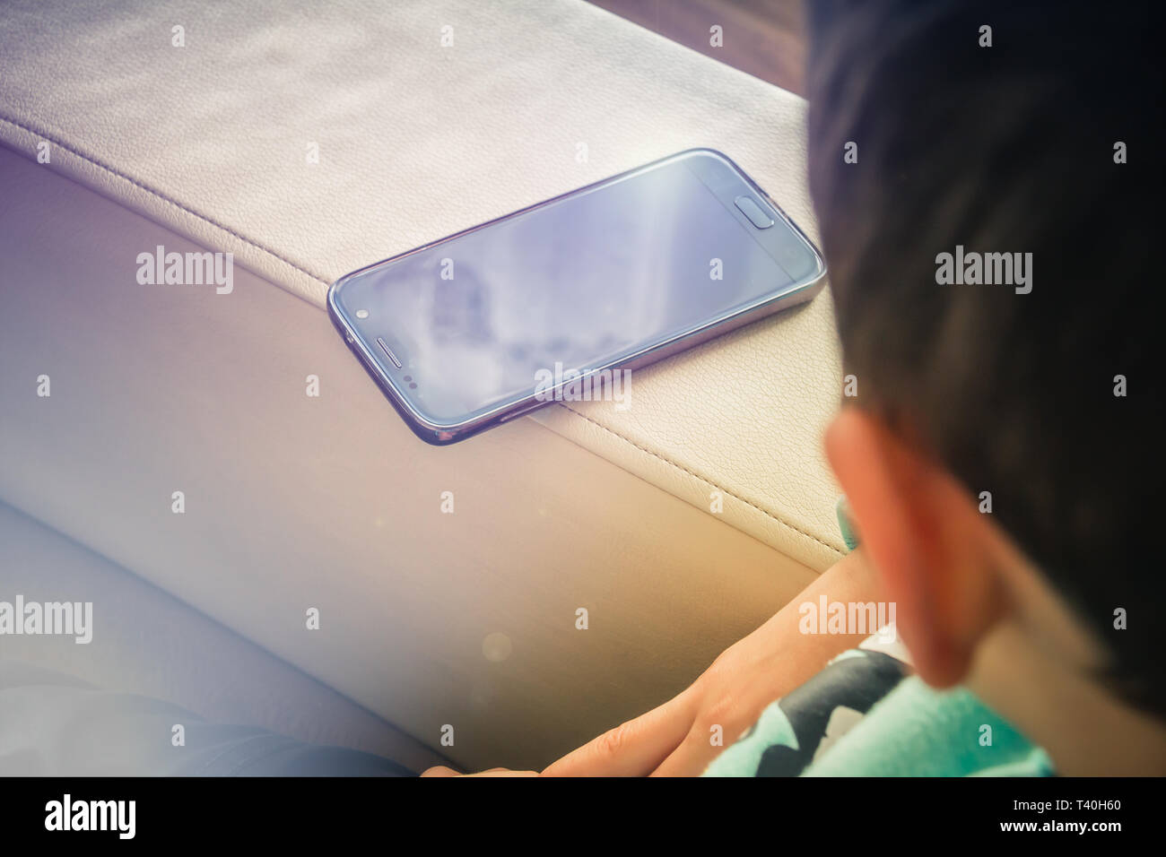 Little boy using a mobile phone at home Stock Photo - Alamy