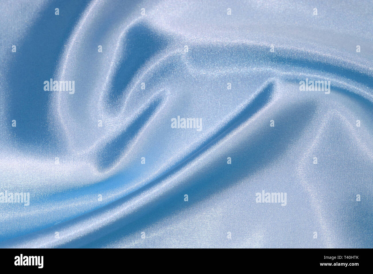 The texture of the blue material. Bright blue silk. Blue background for ...