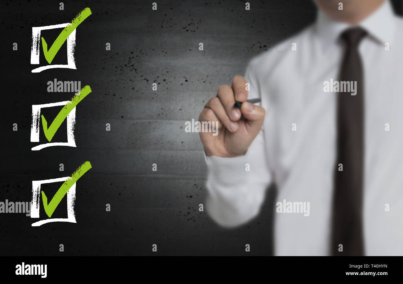 Checklist is written by businessman on computer screen Stock Photo - Alamy