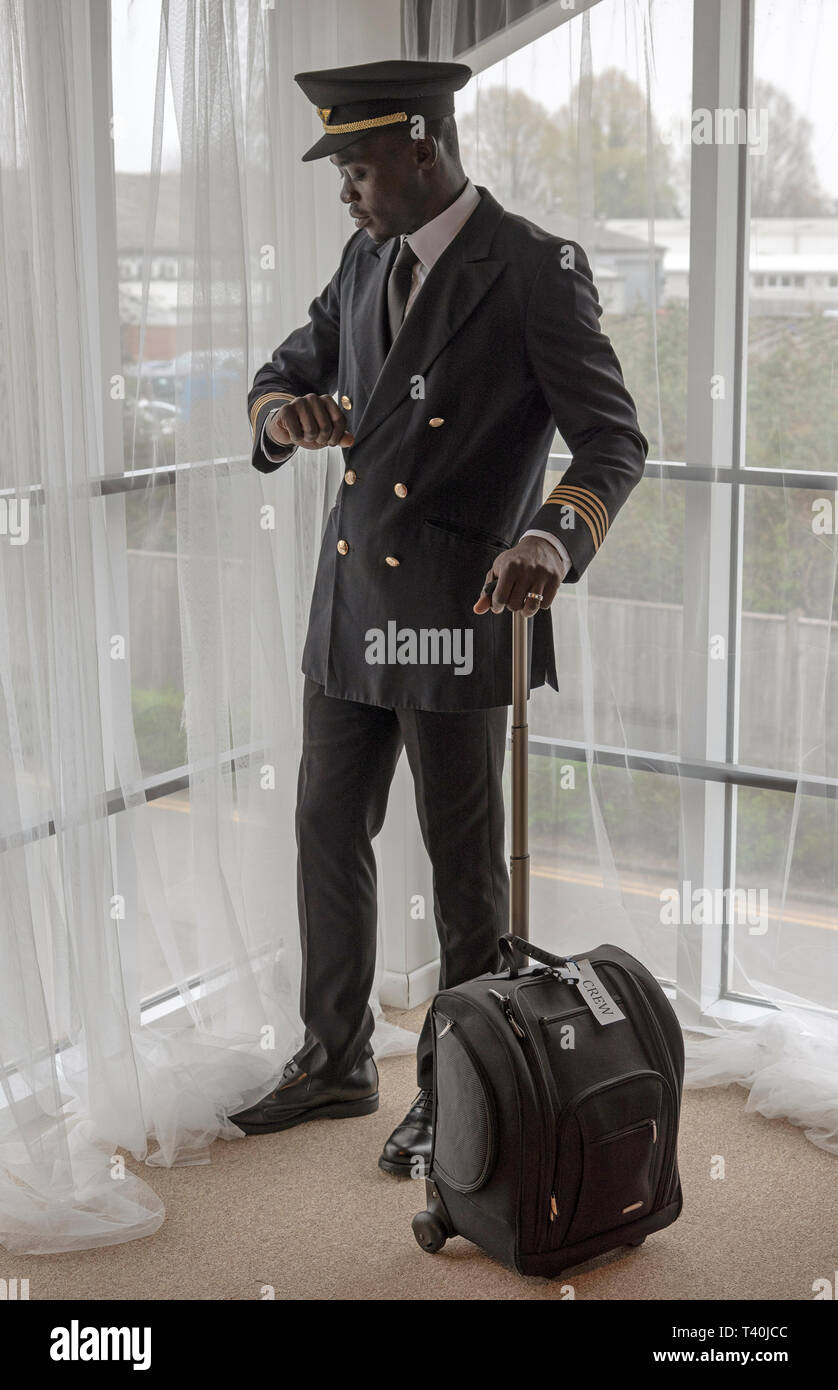 Pilot cabin crew checking time hi-res stock photography and images - Alamy