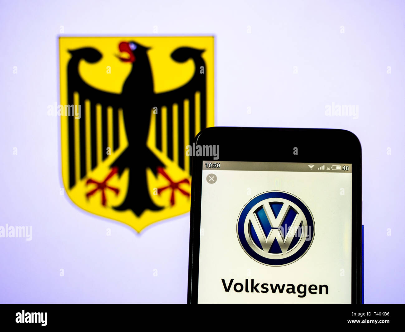 In this photo illustration a Volkswagen logo seen displayed on a smart ...