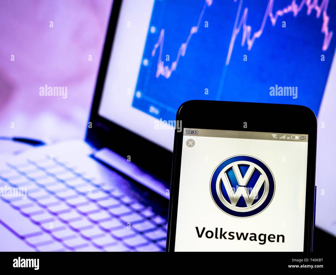 In this photo illustration a Volkswagen logo seen displayed on a smart ...