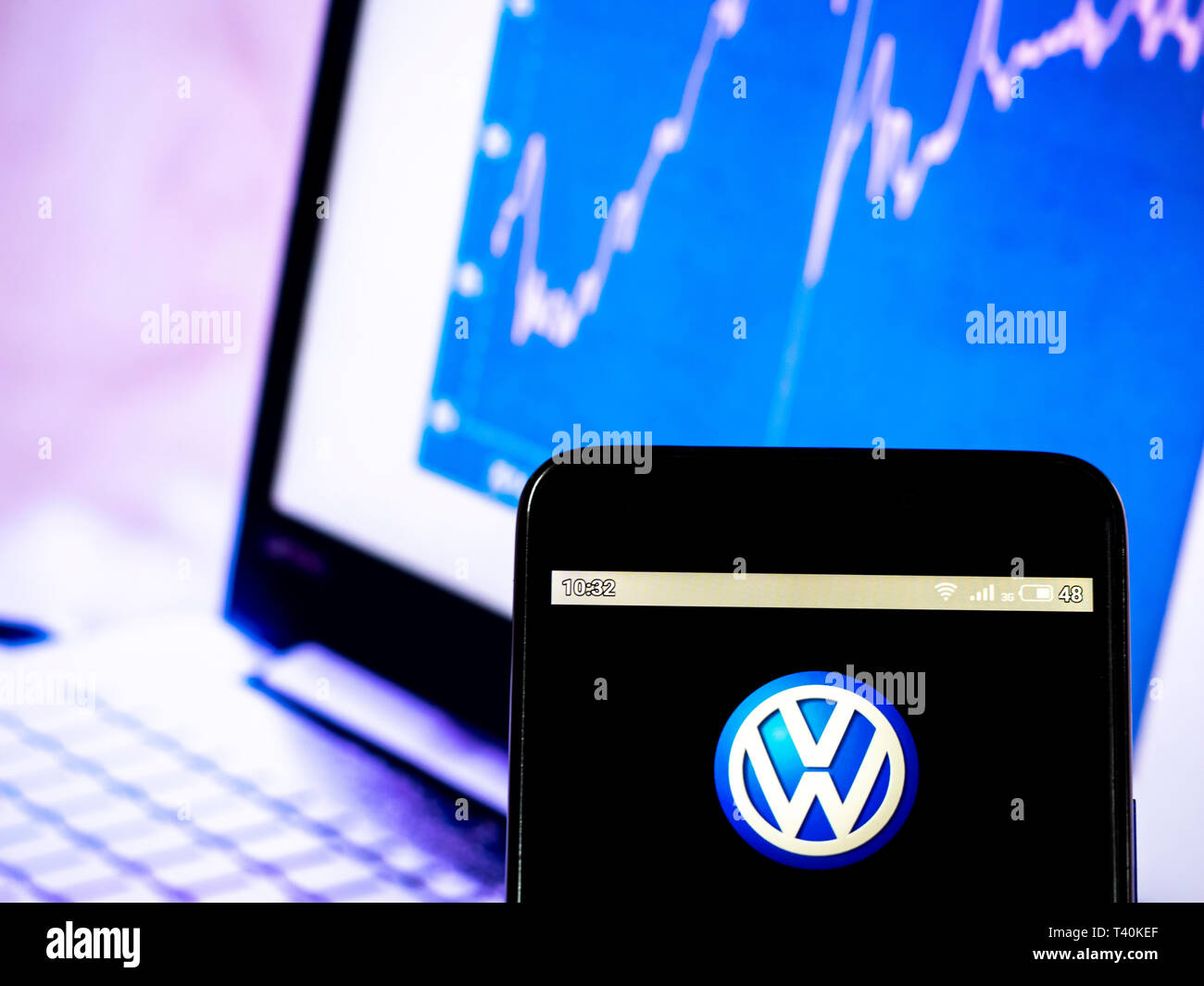 In this photo illustration a Volkswagen logo seen displayed on a smart ...