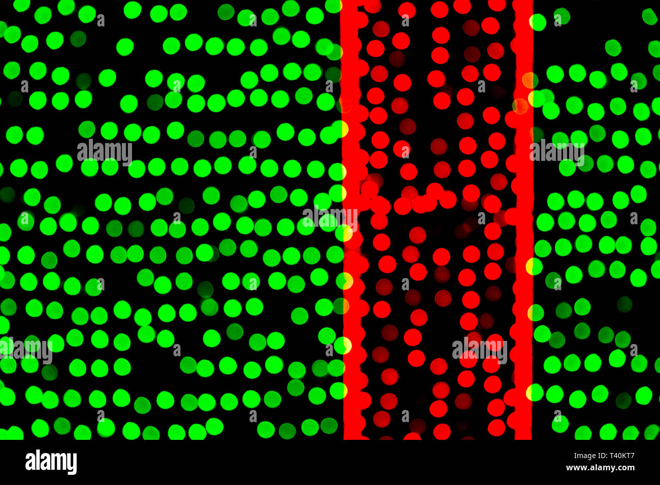 Unfocused abstract green and red bokeh on black background. defocused ...