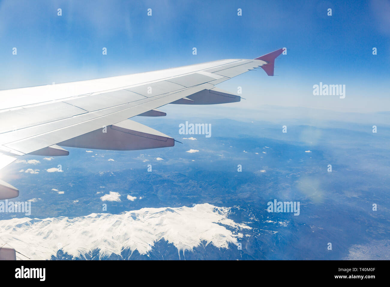 view from the window of the plane that flies over the mountains Stock ...