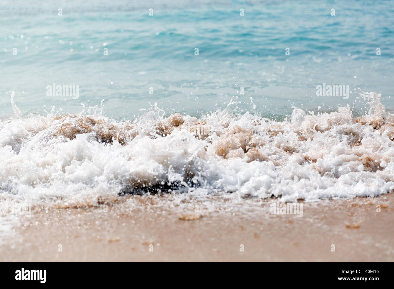 Close up sea waves with splashes on sand beach. Close up Stock Photo ...
