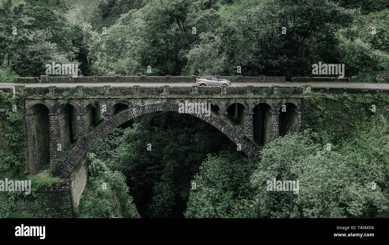 Drone aerial view of a tone bridge crosses a stream in Cruzinhas, Faial ...