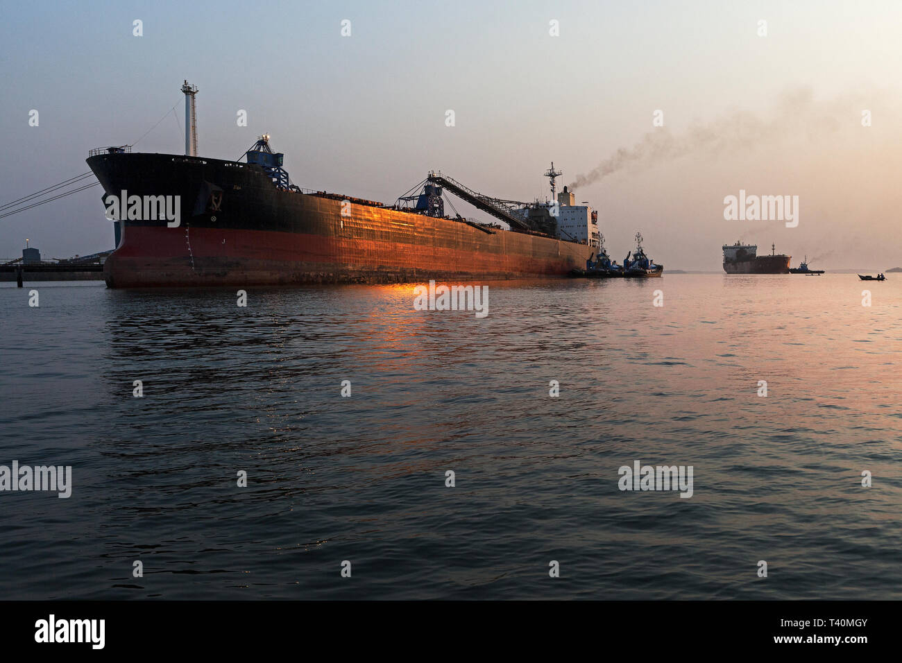 Port operations for managing and transporting iron ore at dawn and ...