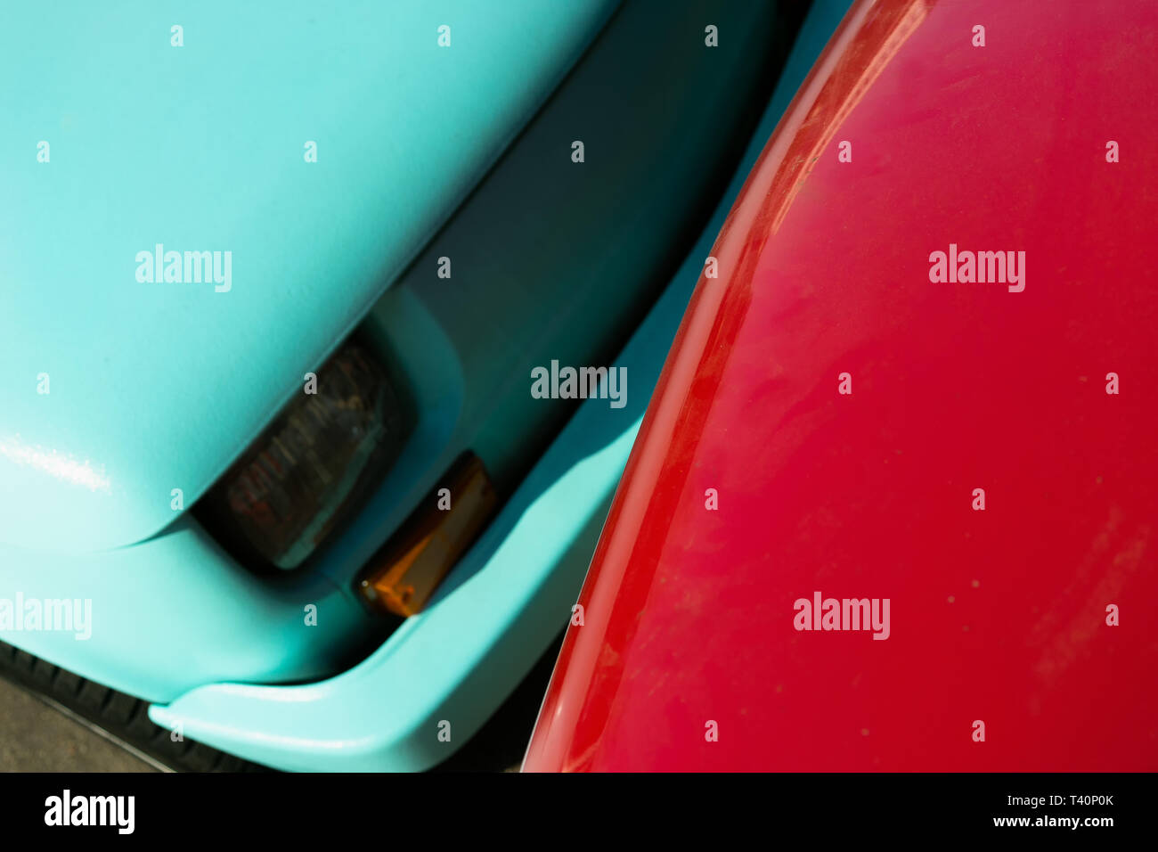 Three cars of different colors are in a row behind each other on the ...