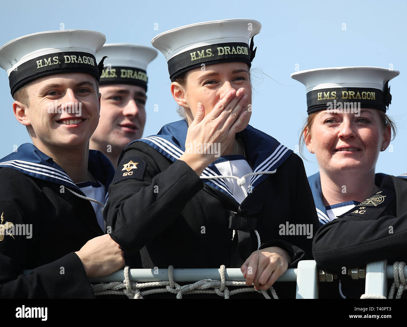 A crew member blows a kiss onboard HMS Dragon as she returns to ...