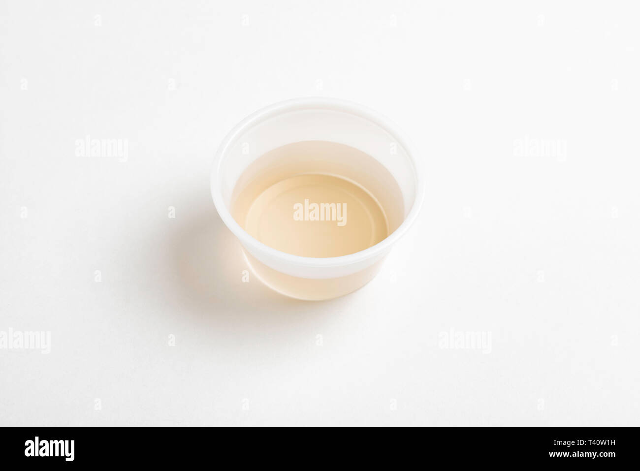 A small round plastic container as liquid specimen holder for medical ...