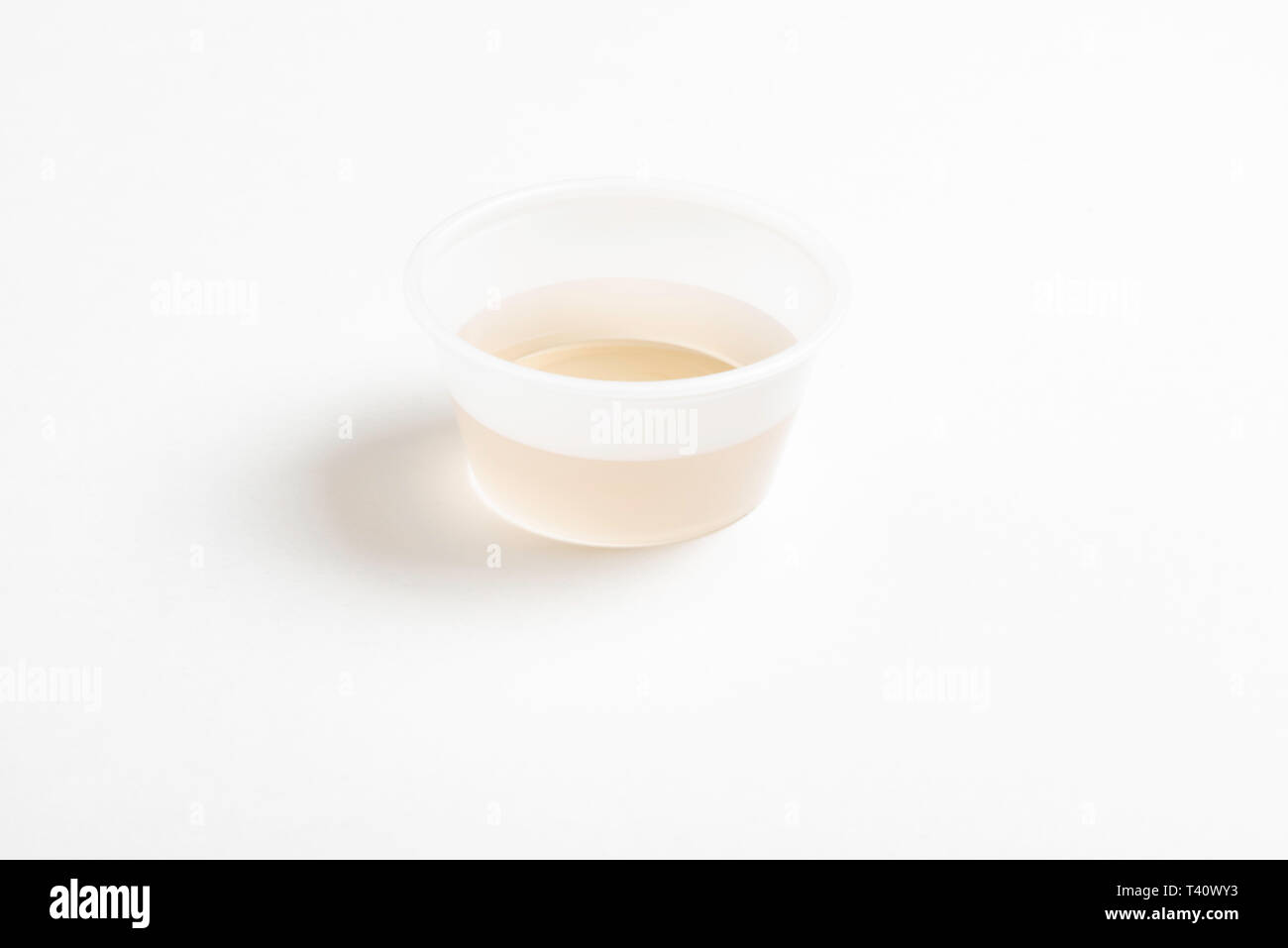 A small round plastic container as liquid specimen holder for medical ...