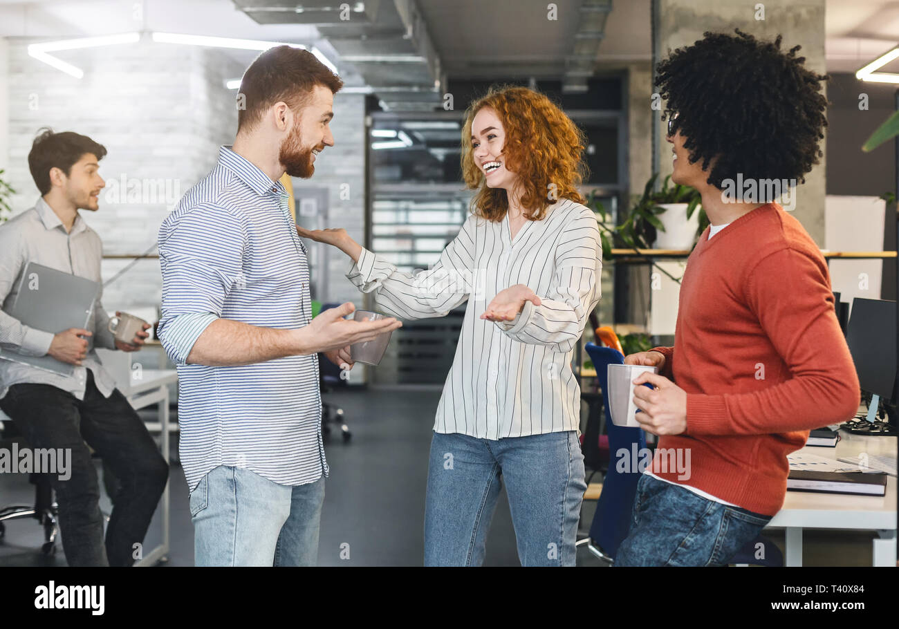 Very friendly girl hugging new colleague in office Stock Photo - Alamy