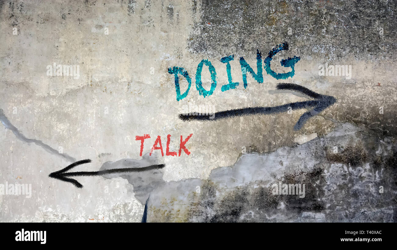 Street Graffiti Doing versus Talk Stock Photo - Alamy