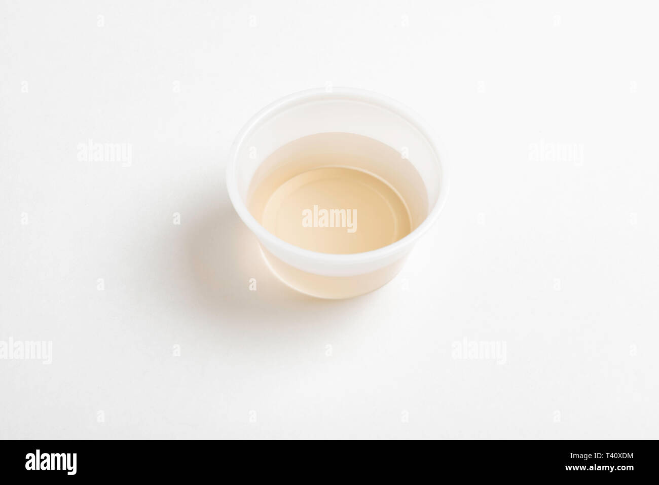 A small round plastic container as liquid specimen holder for medical ...