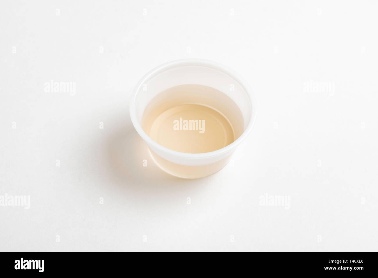 A small round plastic container as liquid specimen holder for medical ...