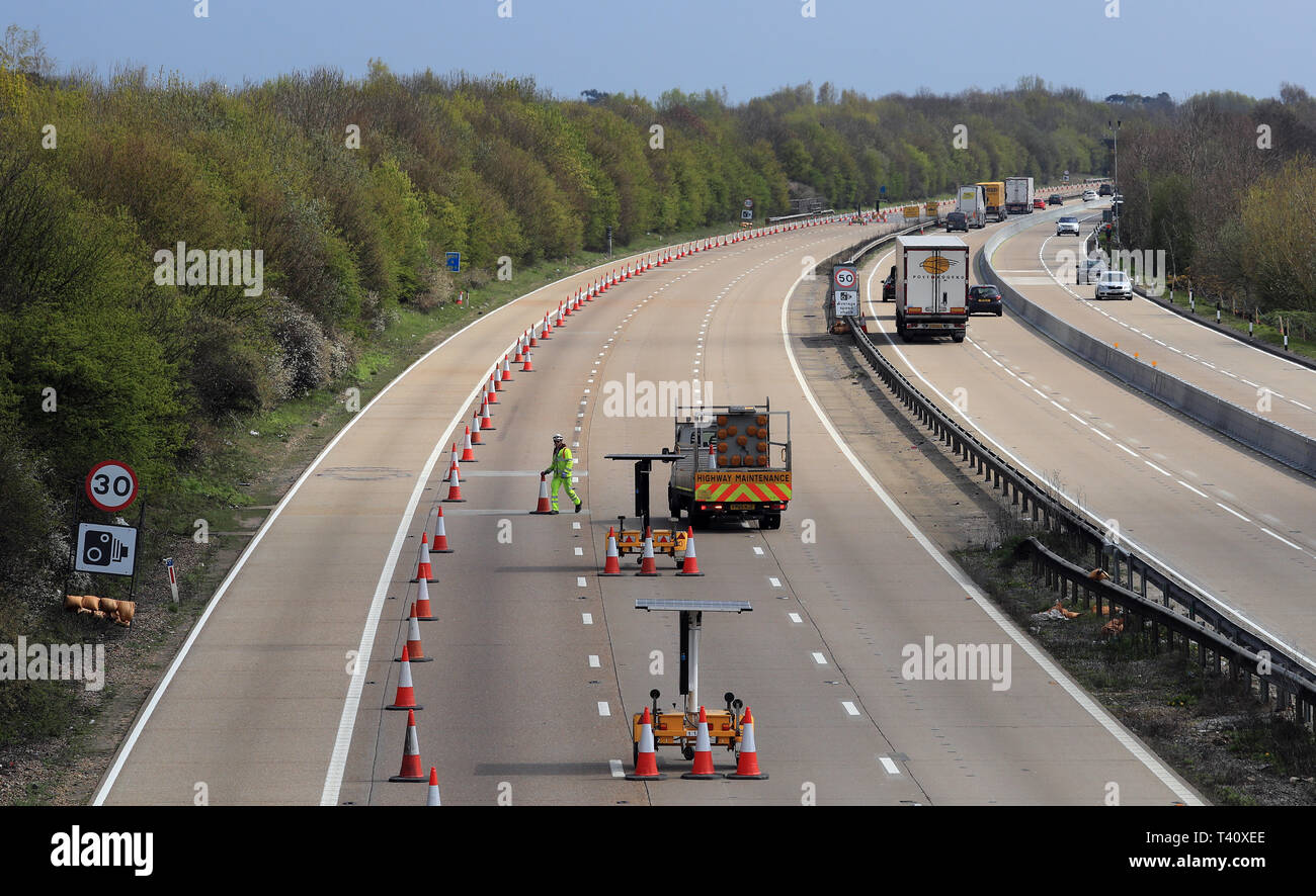 A workman straightens traffic cones on the M20 motorway near Ashford in ...