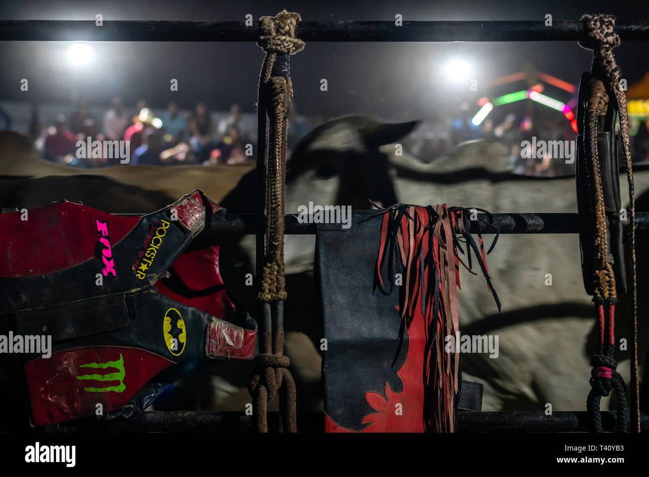 bull riding gear hanging on gate in Guatemalan rodeo Stock Photo - Alamy