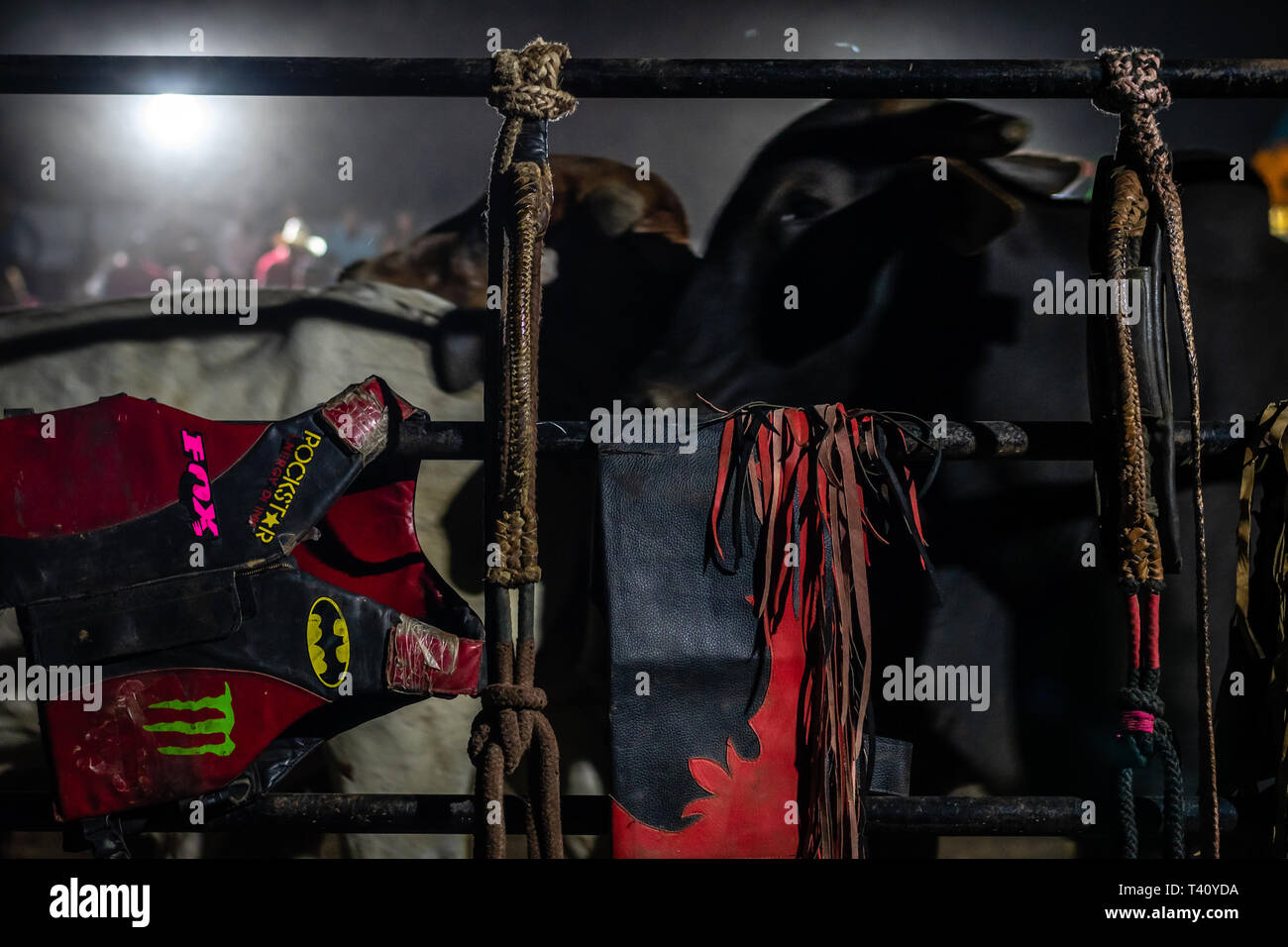 bull riding gear hanging on gate in Guatemalan rodeo Stock Photo - Alamy