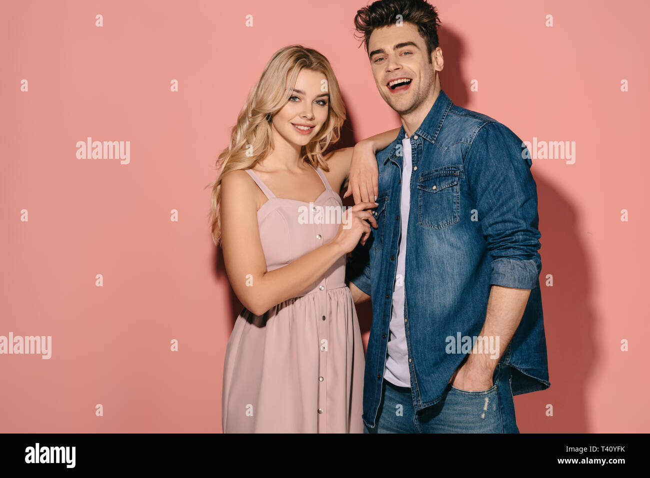 smiling girlfriend and handsome boyfriend in denim shirt hugging on ...