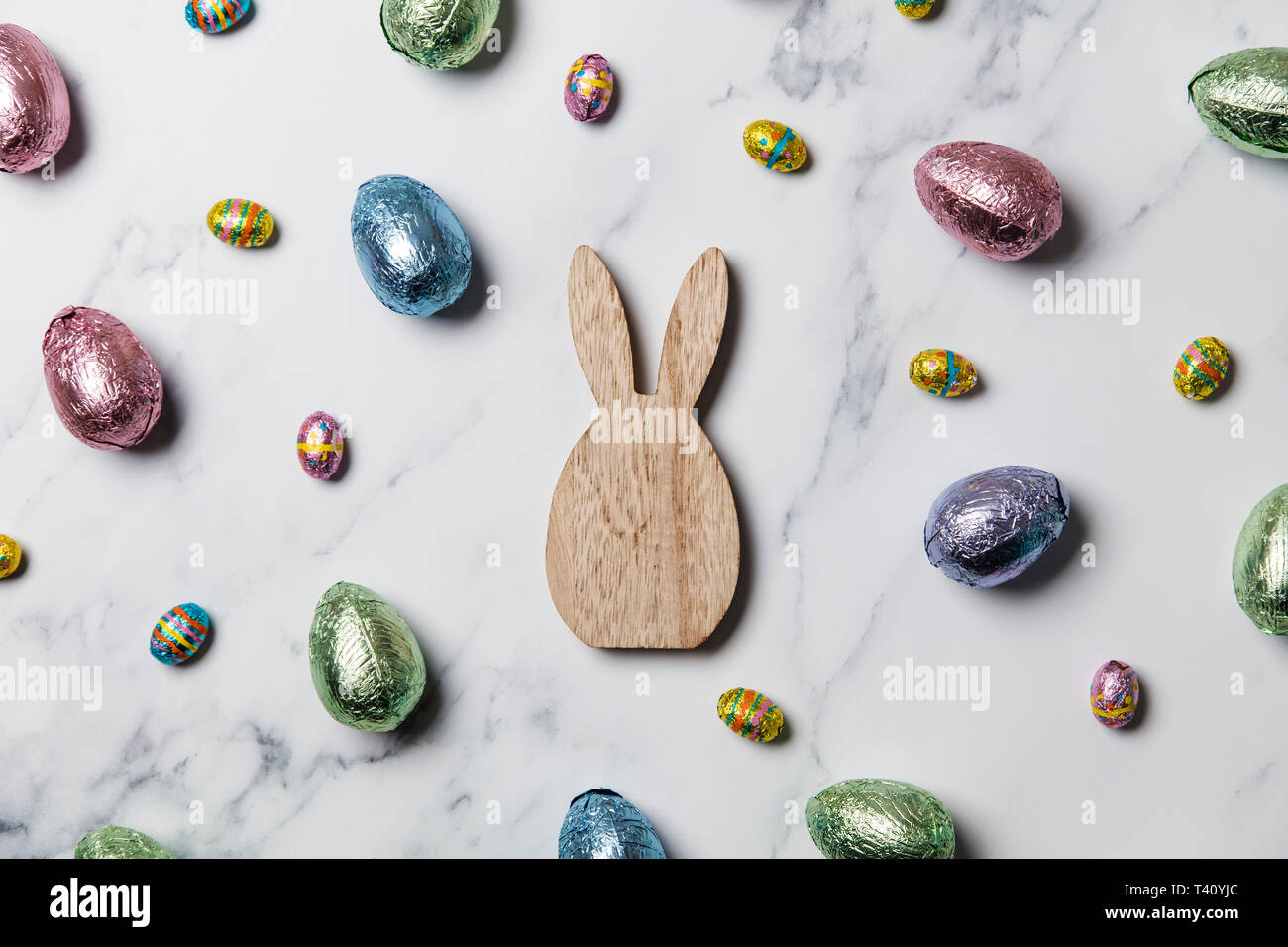 Easter bunny with foil wrapped chocolate easter eggs Stock Photo - Alamy