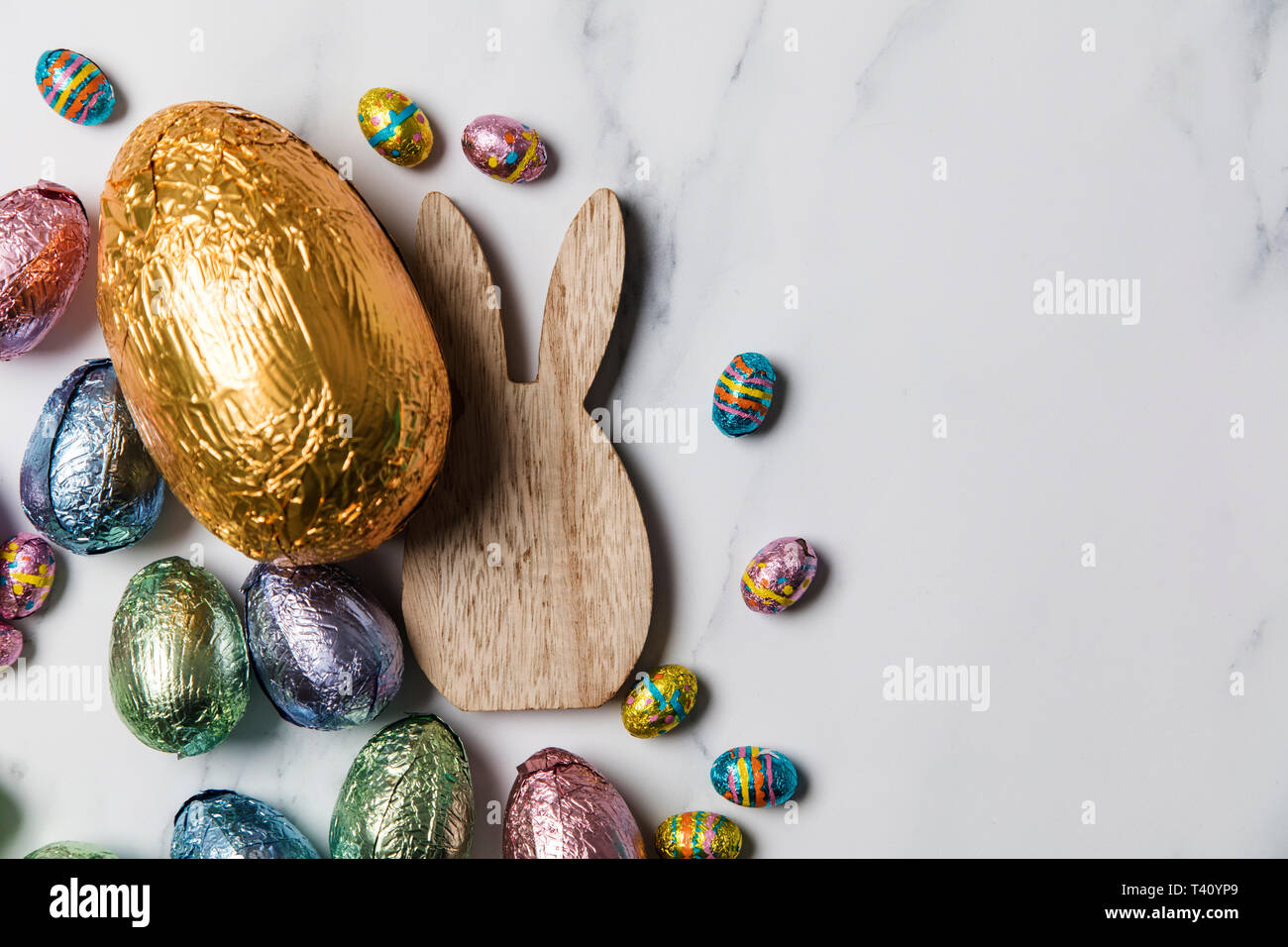 Easter bunny with foil wrapped chocolate easter eggs Stock Photo - Alamy