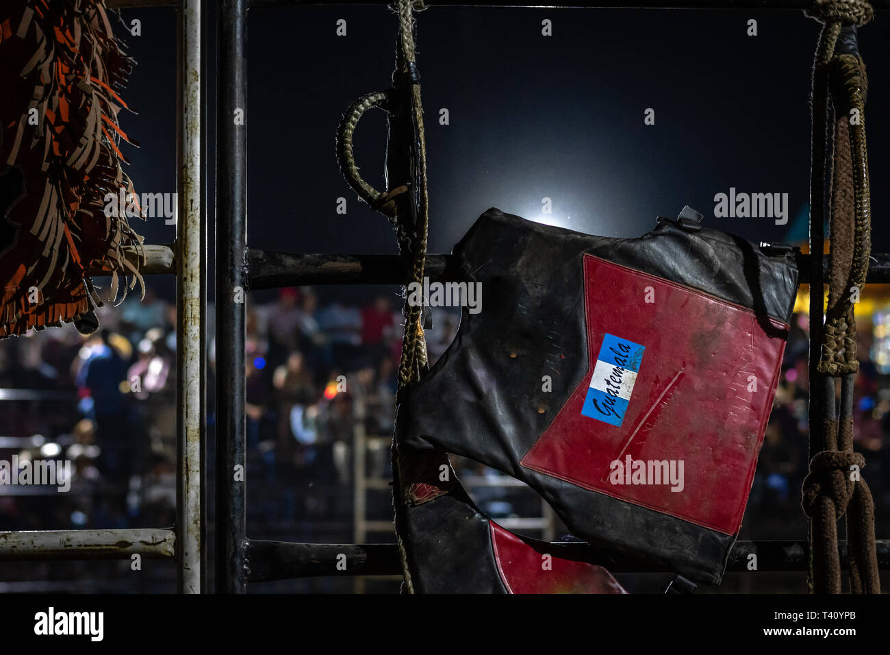 bull riding gear hanging on gate in Guatemalan rodeo Stock Photo - Alamy