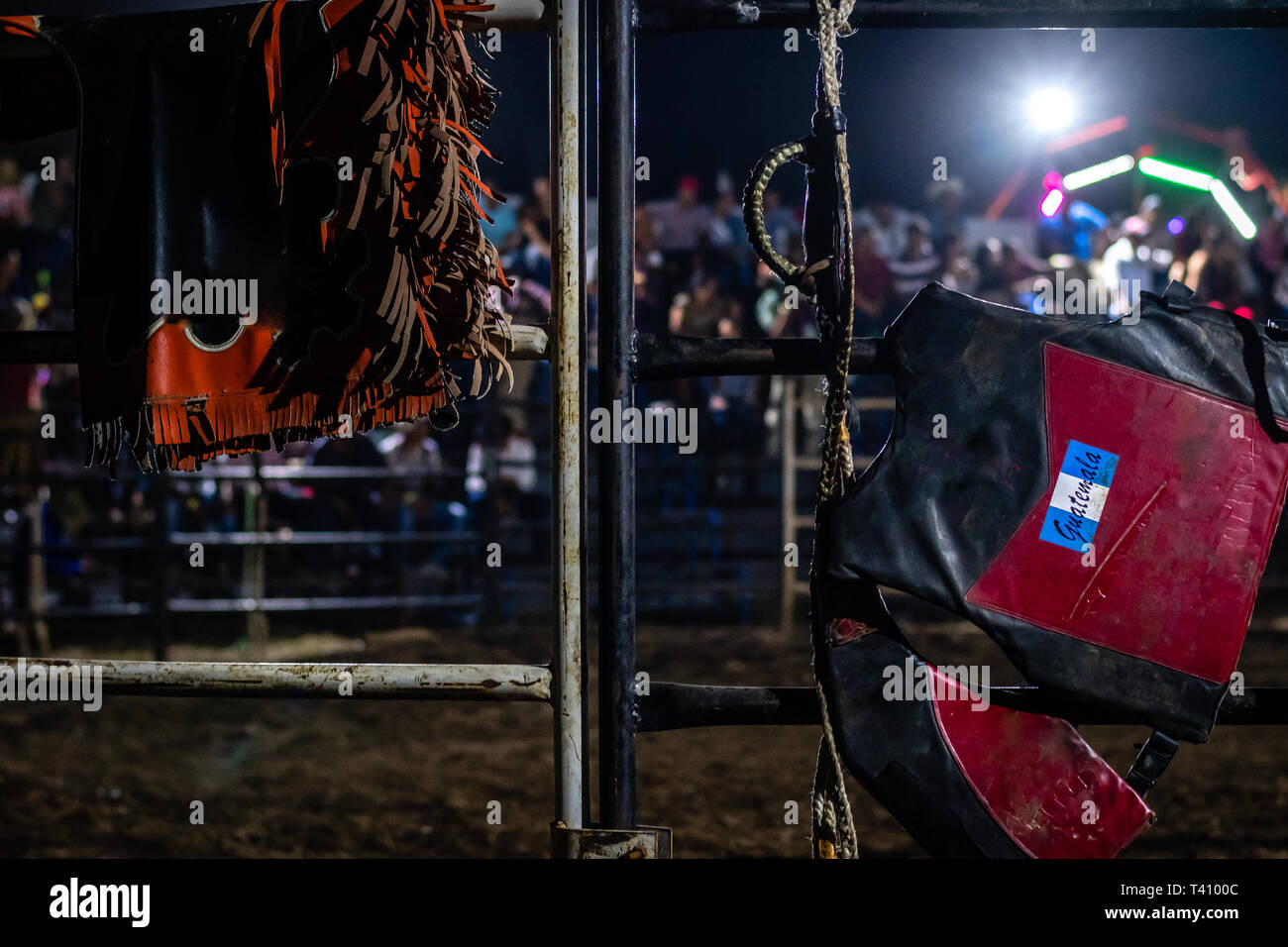 bull riding gear hanging on gate in Guatemalan rodeo Stock Photo - Alamy