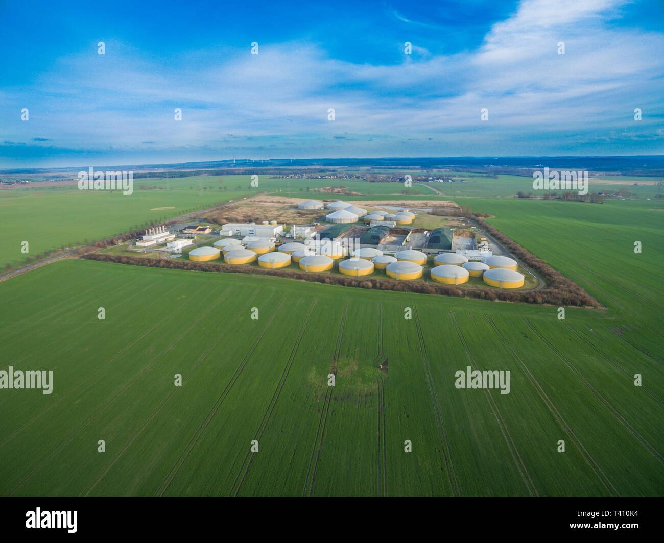 Aerial view of a big biogas plant between green agricultural fields in ...