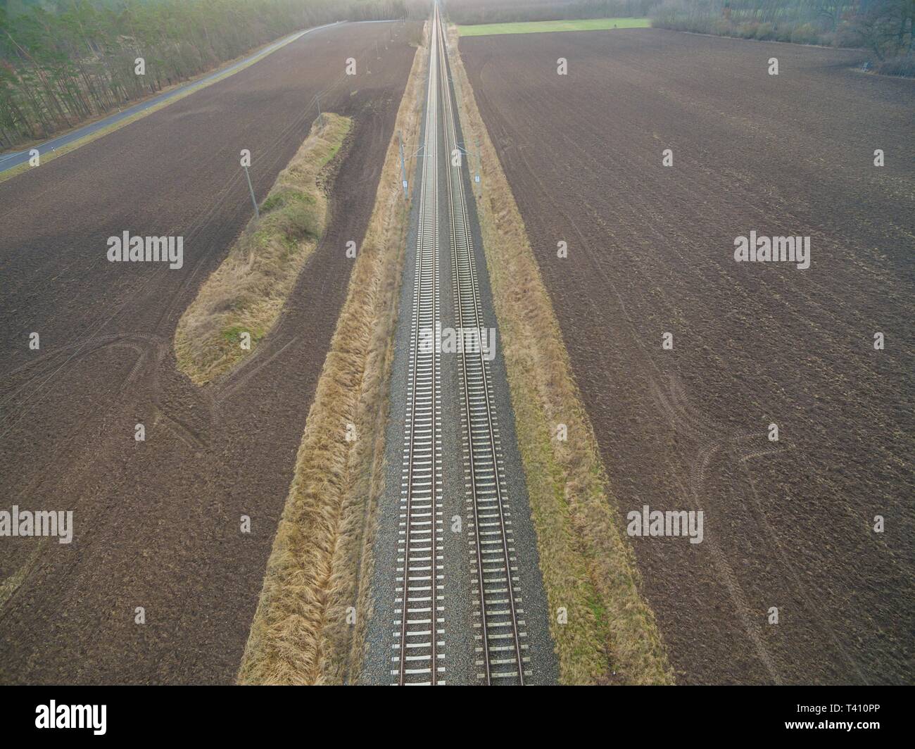aerial view of railroad tracks in the backcountry between freshly ...