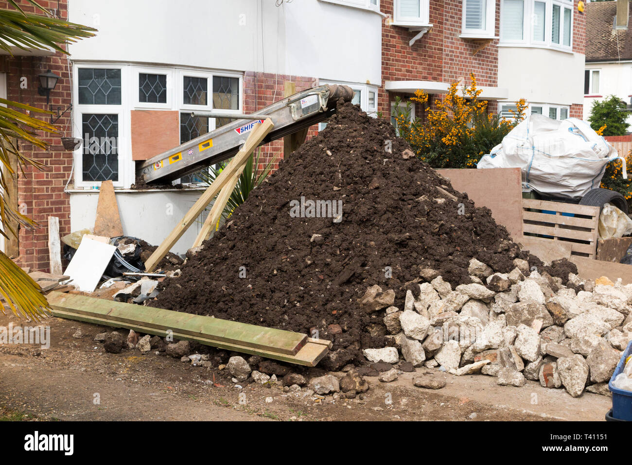 Machine / conveyor belt removing soil debris and spoil waste from house ...