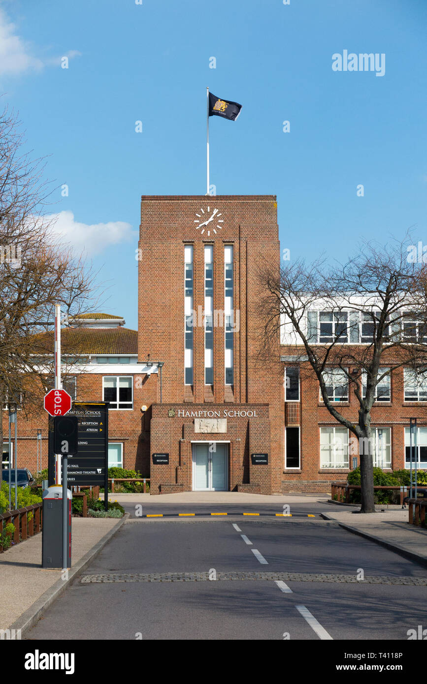 (Front exterior facade of Hampton School with flag flying. It is an ...