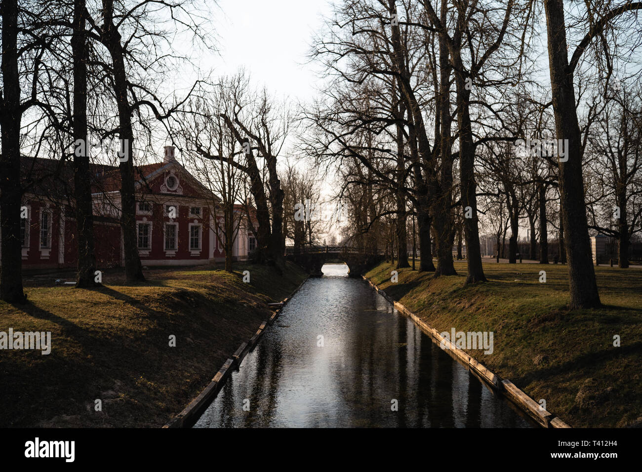 Spring park with a canal and a bridge in the background Stock Photo - Alamy