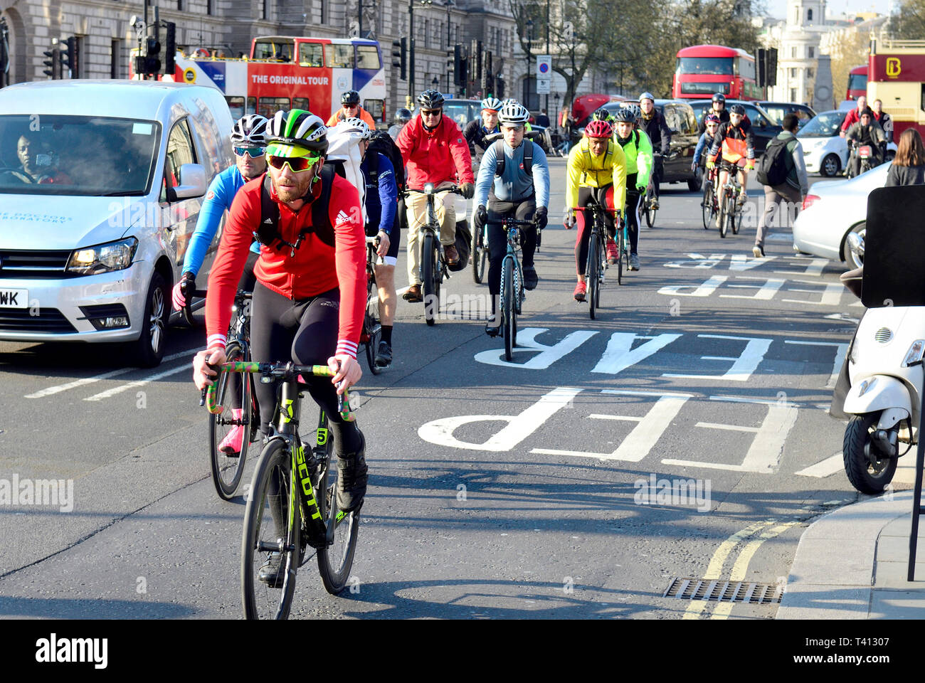 London, England, UK. Cyclists wearing brightly-coloured clothing in ...
