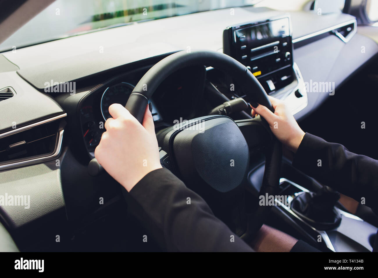 Woman driving a car, hands on steering wheel close-up Stock Photo - Alamy
