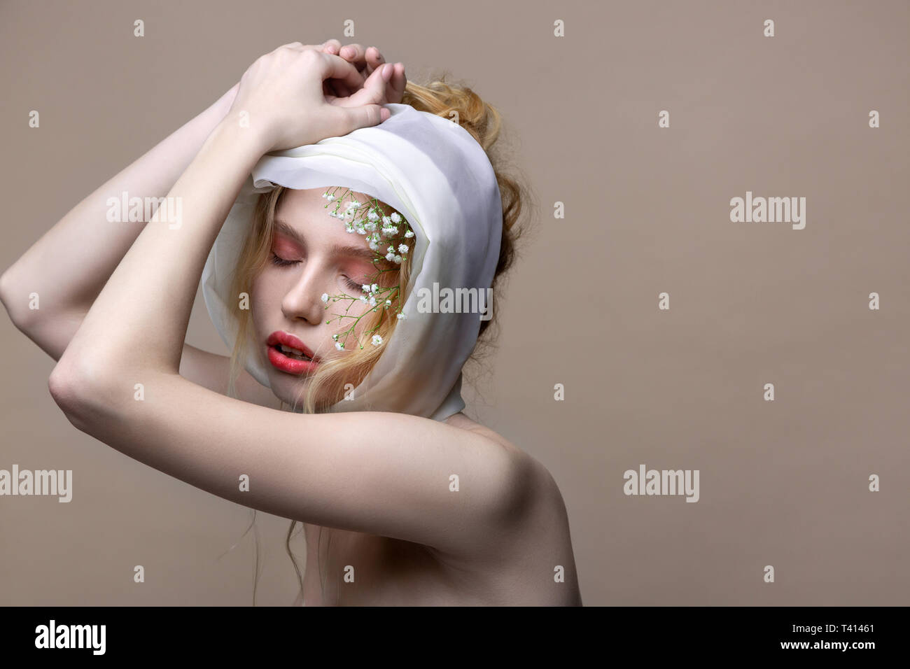 Model with open shoulders having flowers and silk scarf on hair Stock ...