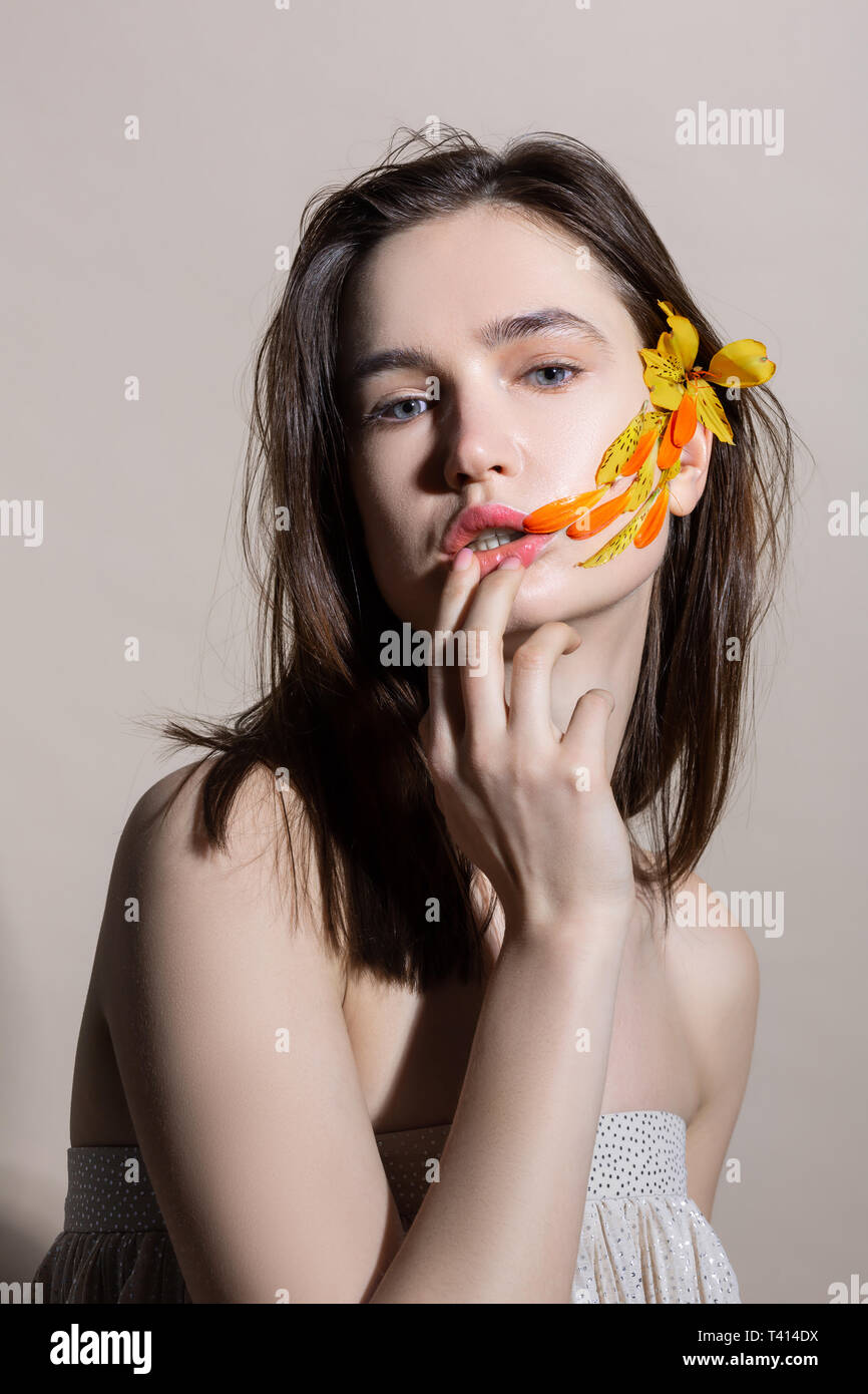 Model with straight dark hair wearing open shoulder blouse Stock Photo ...