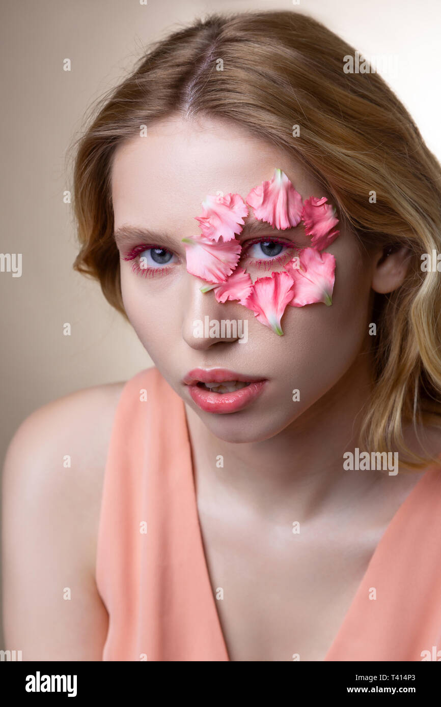 Professional model working showing poses with petals on face Stock ...