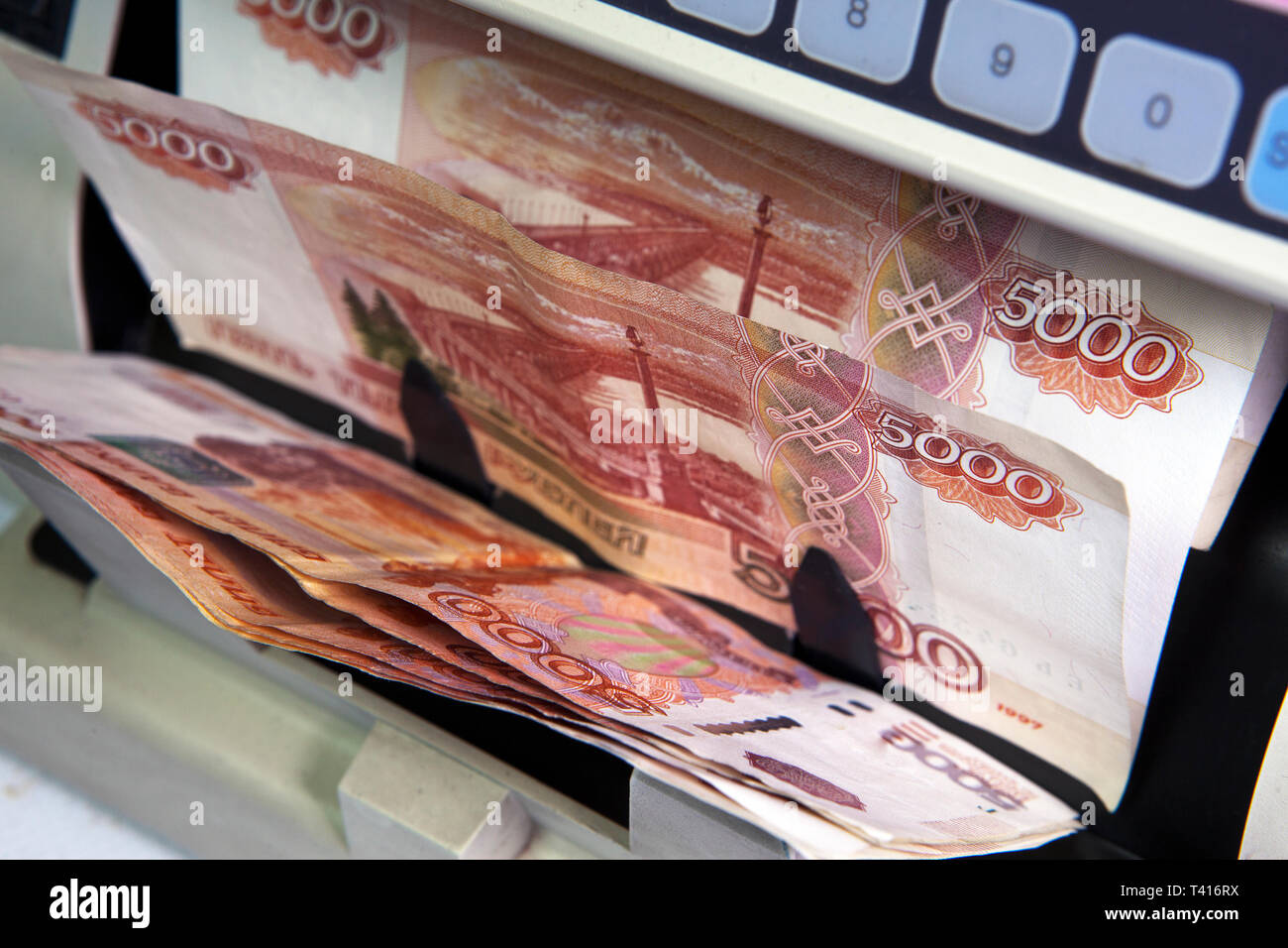 Electronic money counter machine is counting the Russian five ...