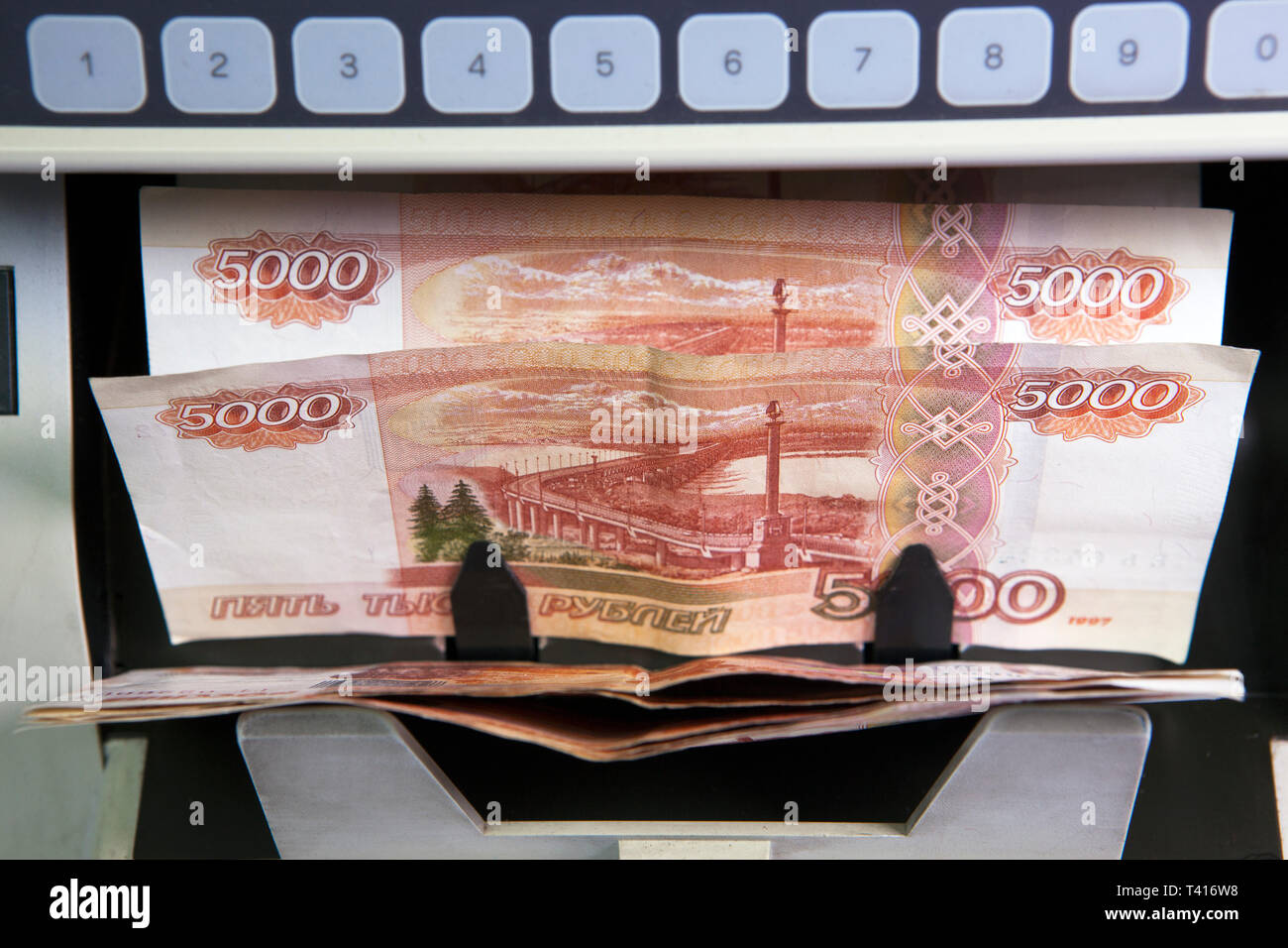 Electronic money counter machine is counting the Russian five ...