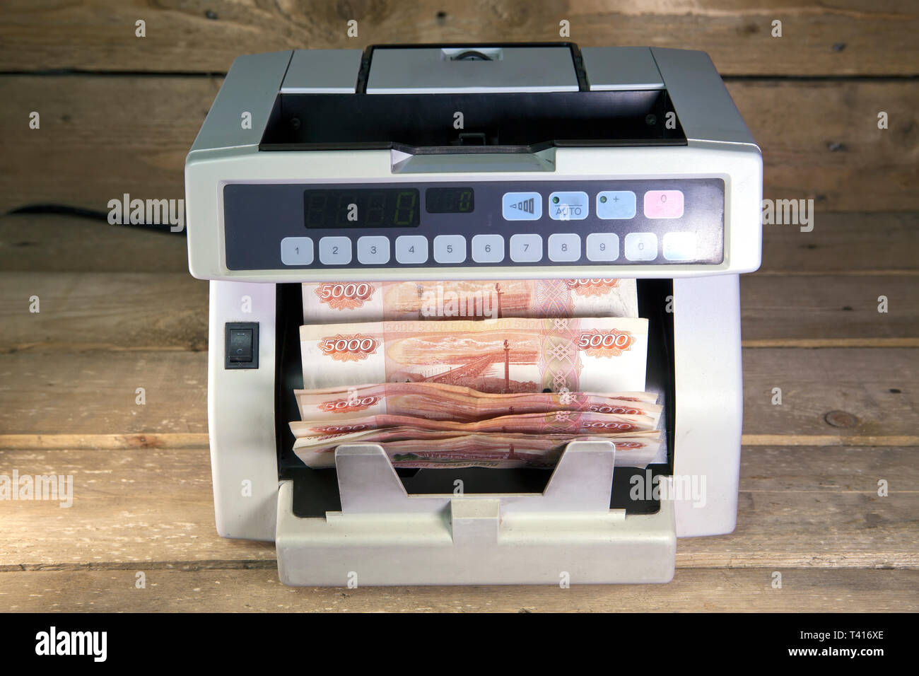 Electronic money counter machine is counting the Russian five ...