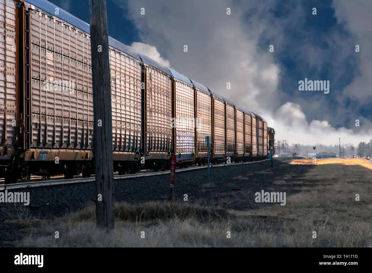 A train hauling new cars in autoracks to be delivered to dealers. They ...