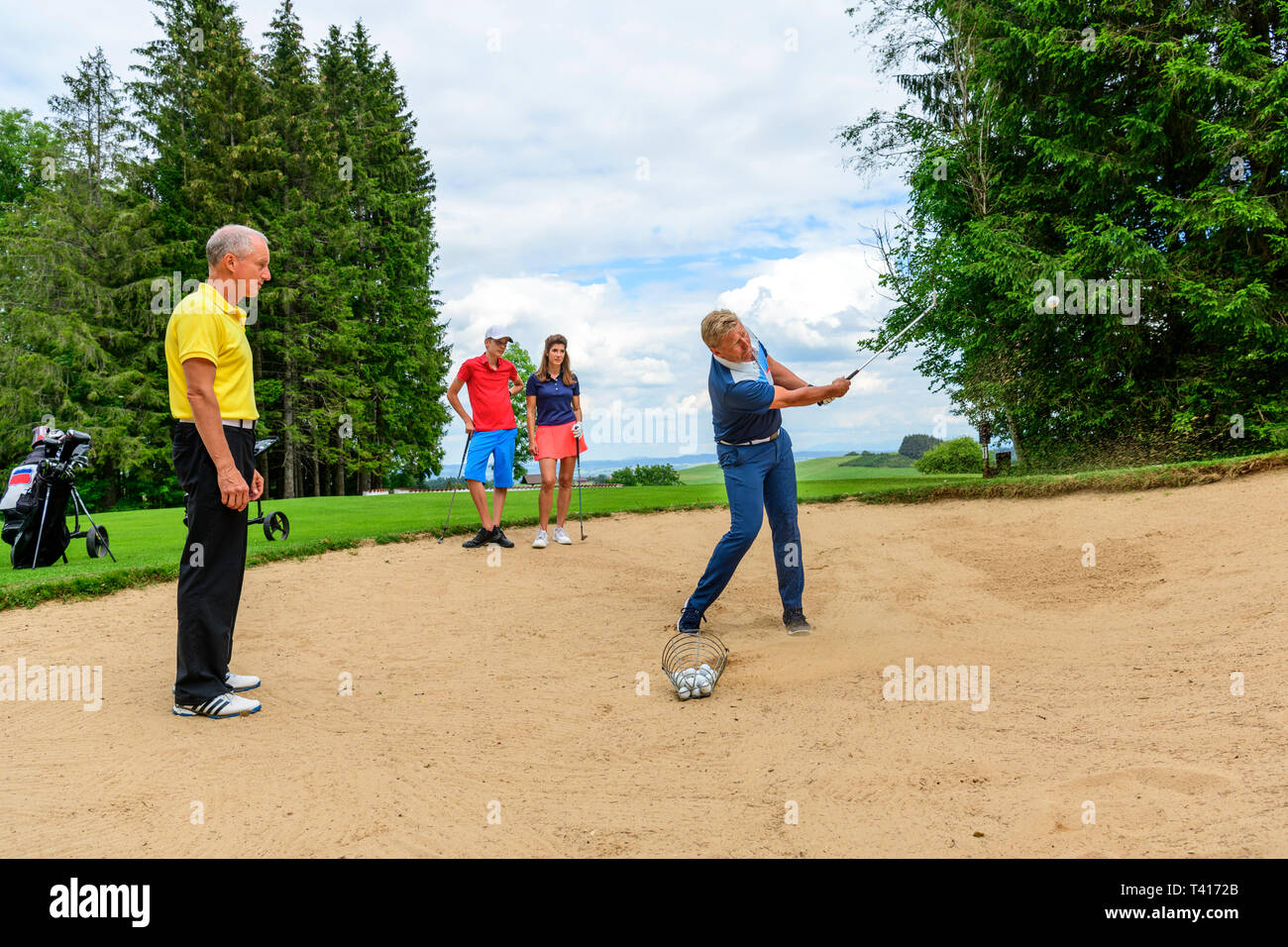 Golf group training lesson in sandbunker Stock Photo - Alamy