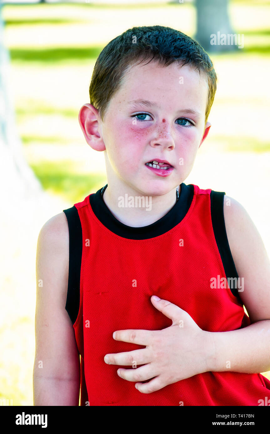 Little boy with a skinned nose playing in the shade of a teen a hot ...