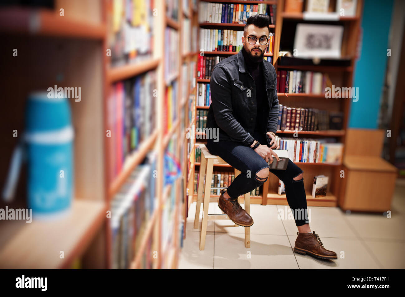 Tall smart arab student man, wear on black jeans jacket and eyeglasses ...