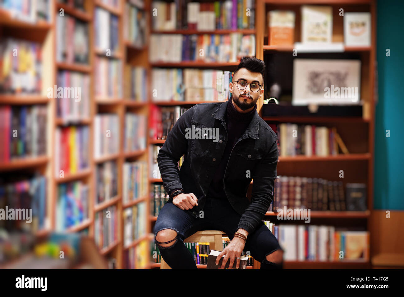Tall smart arab student man, wear on black jeans jacket and eyeglasses ...