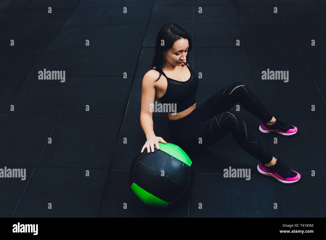 Muscular woman doing intense core workout in gym. Strong female doing ...