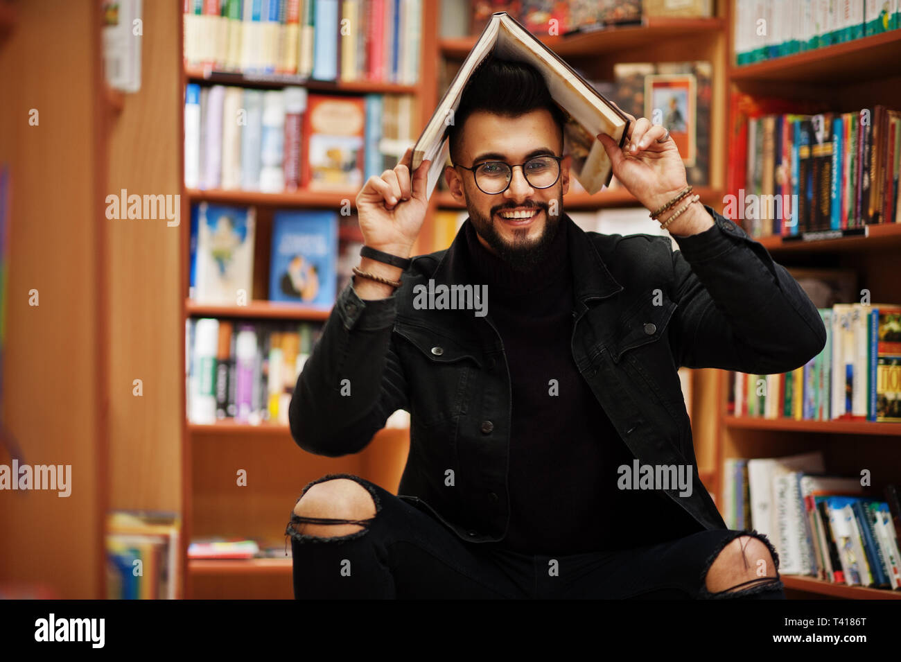 Tall smart arab student man, wear on black jeans jacket and eyeglasses ...