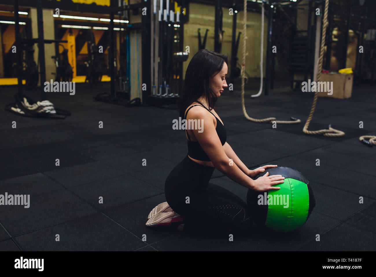 Muscular woman doing intense core workout in gym. Strong female doing ...