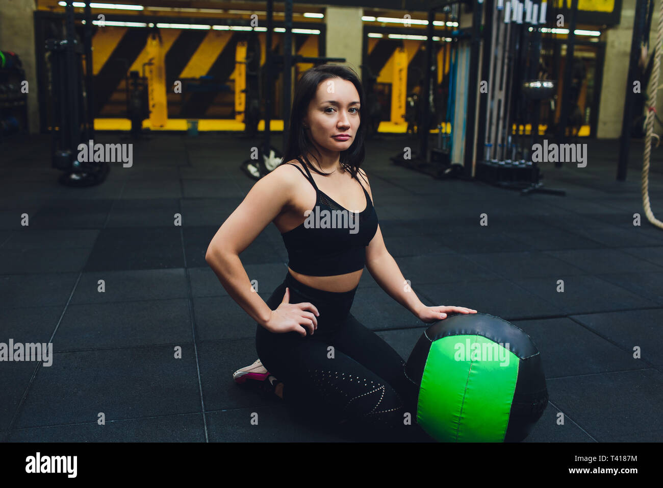 Muscular woman doing intense core workout in gym. Strong female doing ...